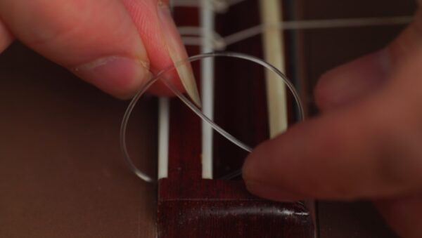 How to change strings on classical guitar