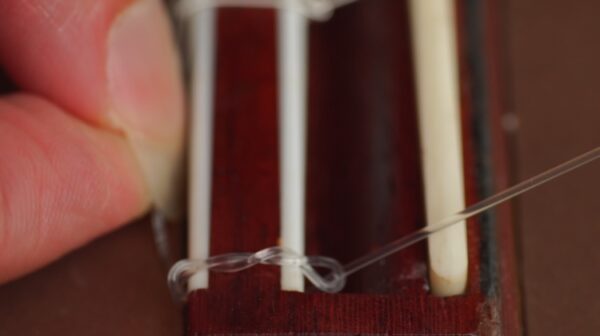 How to change strings on classical guitar