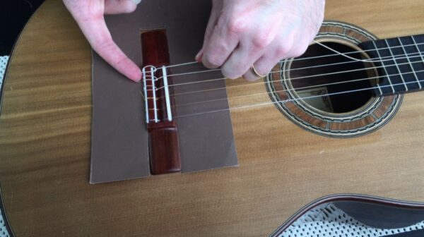 How to change strings on classical guitar