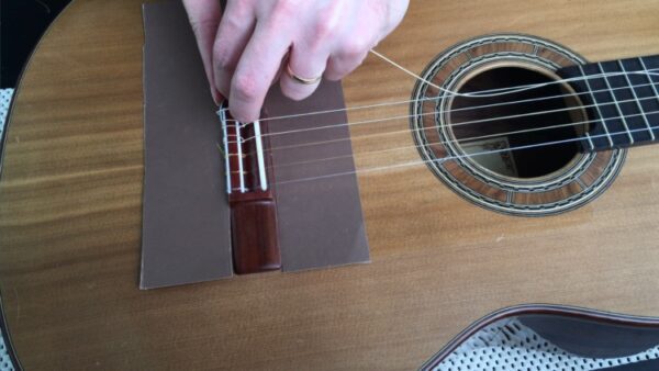 How to change strings on classical guitar